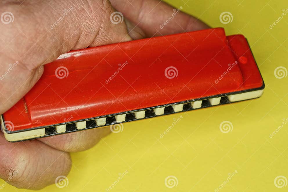 Hand Holding a Red Plastic Harmonica Stock Photo - Image of device ...
