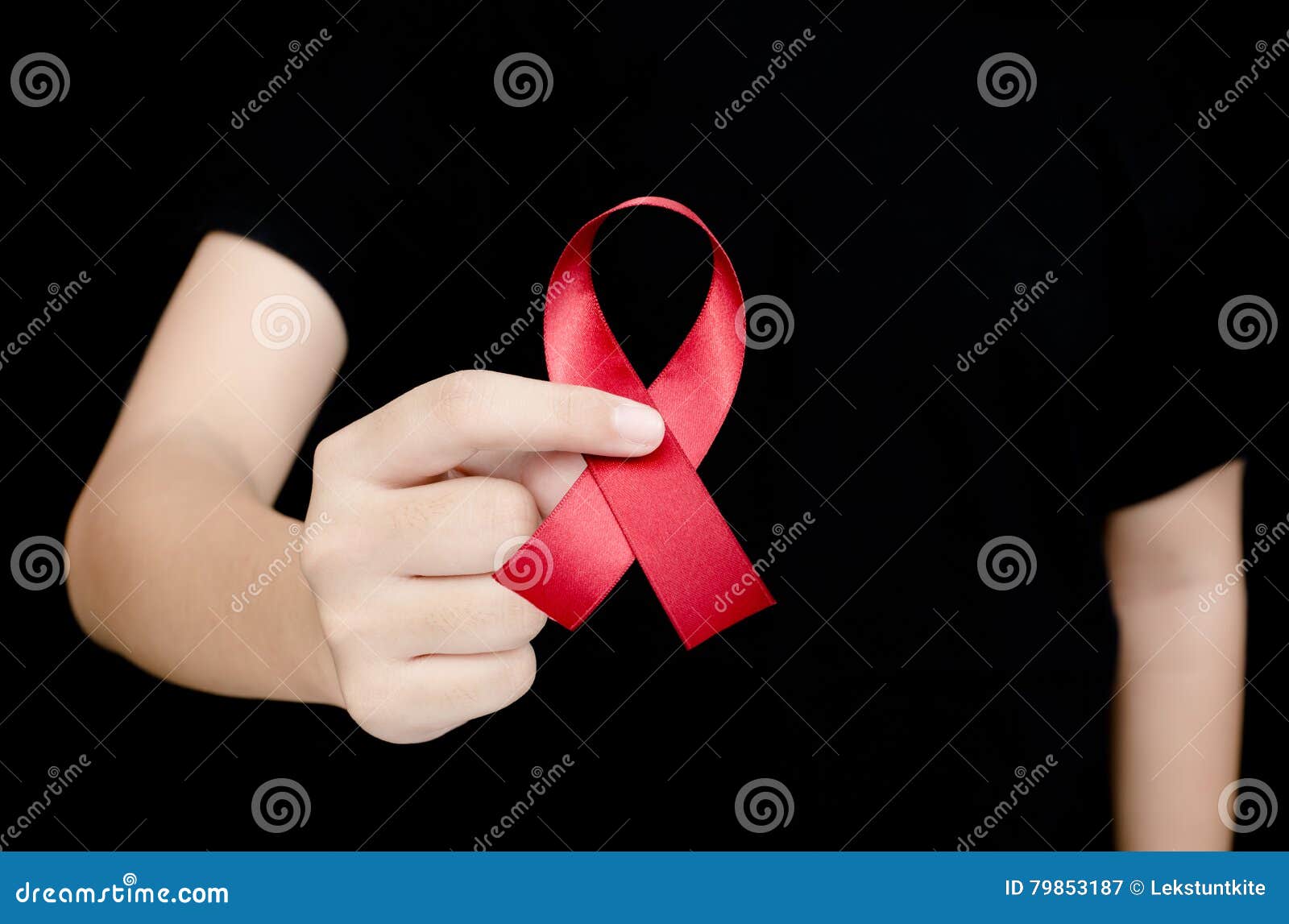 Hand Holding Red Ribbon On Black Background Sign Of World Aids D Stock