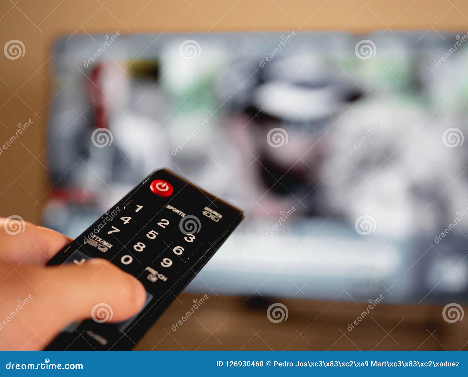 Hand Holding Remote Control in Front of Television Stock Photo - Image ...