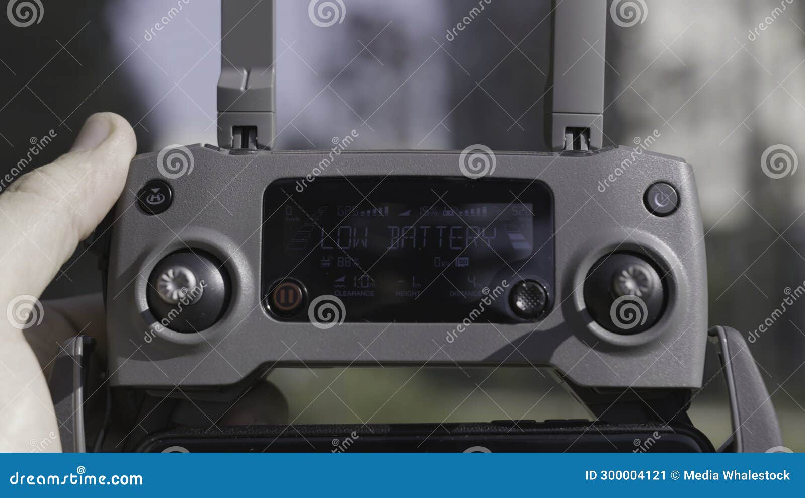 Hand Holding the Remote Controller of a Quadcopter with Low Battery ...