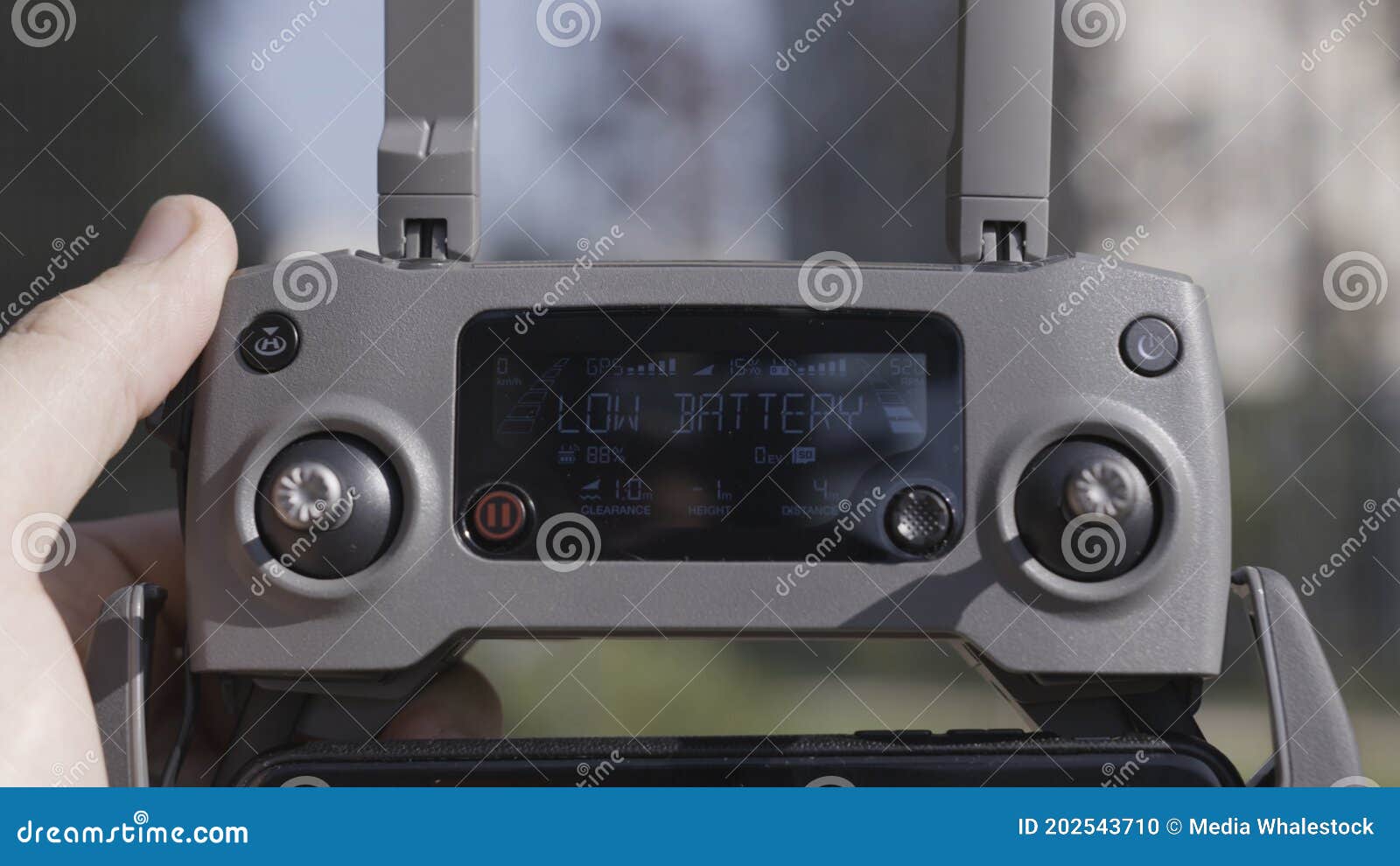 Hand Holding the Remote Controller of a Quadcopter with Low Battery ...