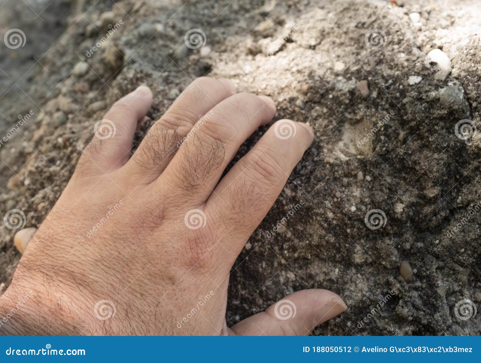 Hand holding the rock stock photo. Image of extreme - 188050512