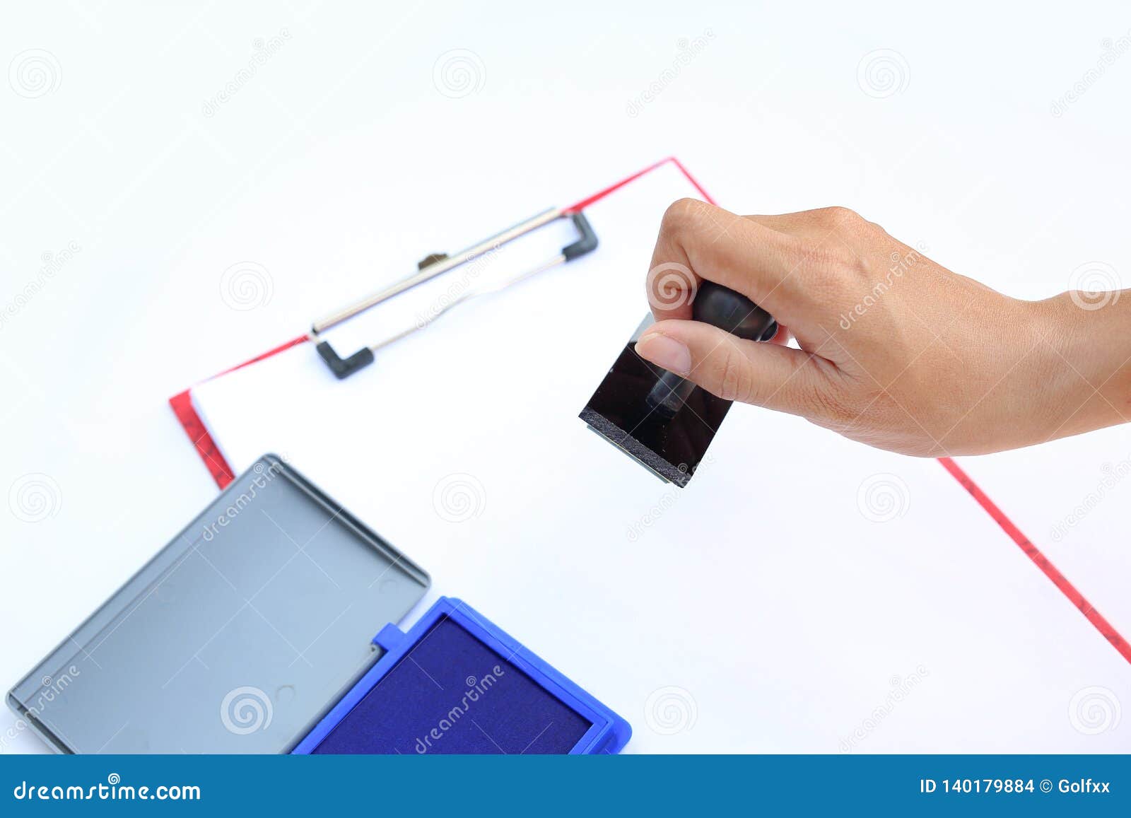 Hand Holding Rubber Stamper with Blue Ink Padbox on White Paper Stock ...