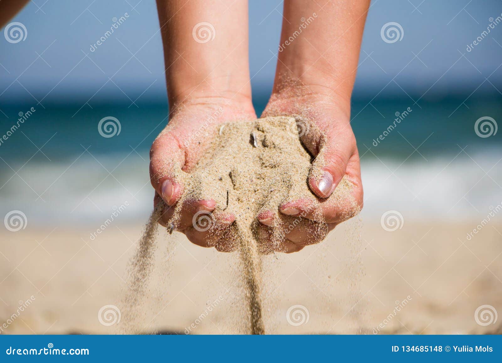 Hand holding sand. stock photo. Image of foot, close - 134685148