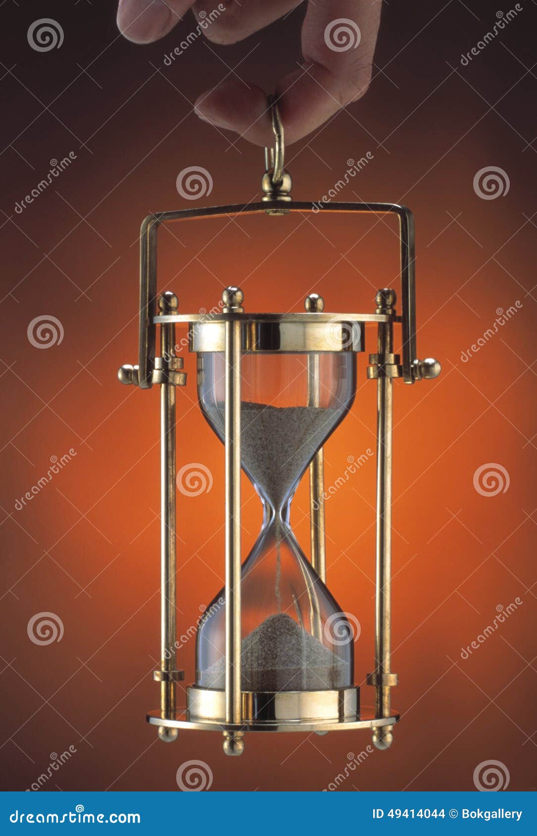 Hand holding sand timer stock photo. Image of attention - 49414044