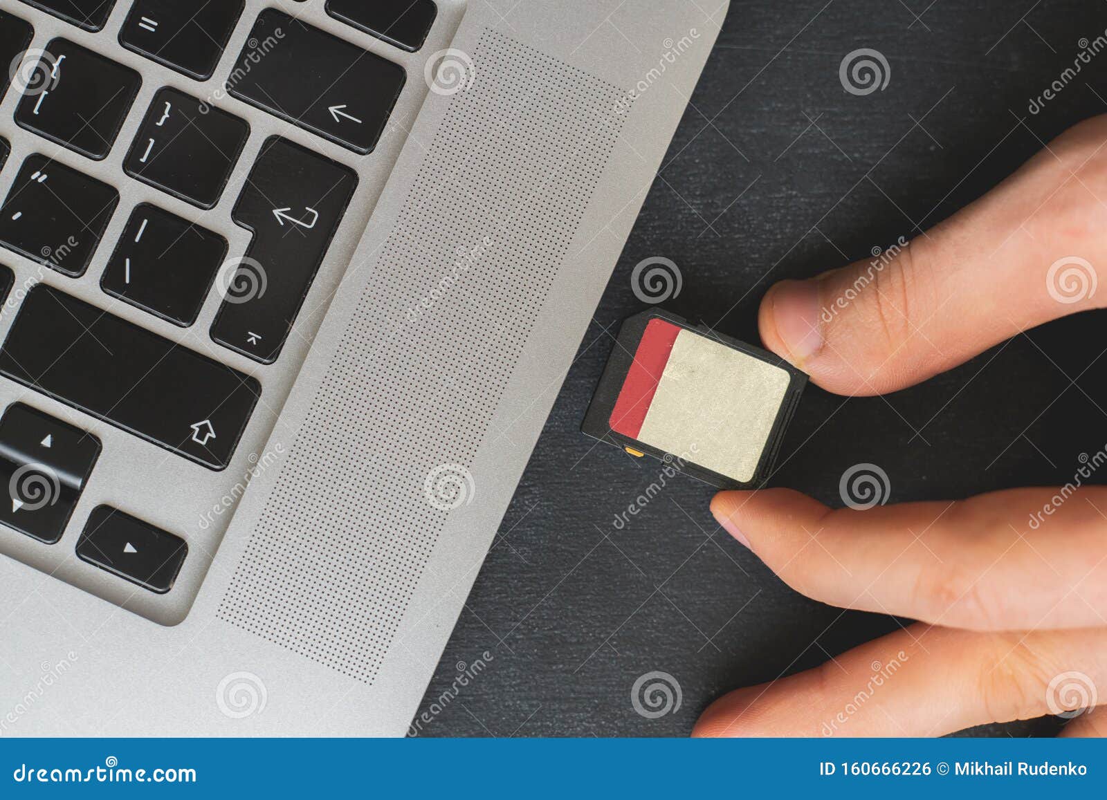 Hand Holding SD Flash Card Drive and Insert it in the Laptops Stock ...