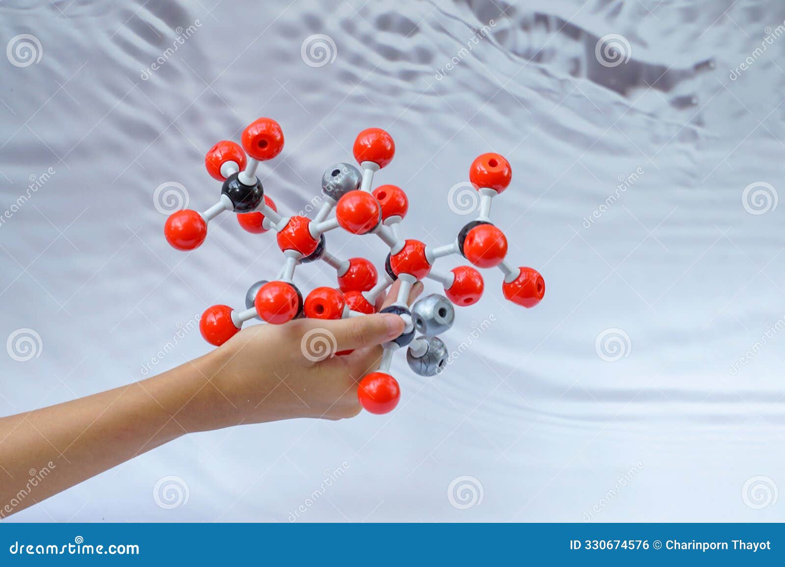 Hand Holding a Simulate Shape of Covalent Molecules on a Gray ...