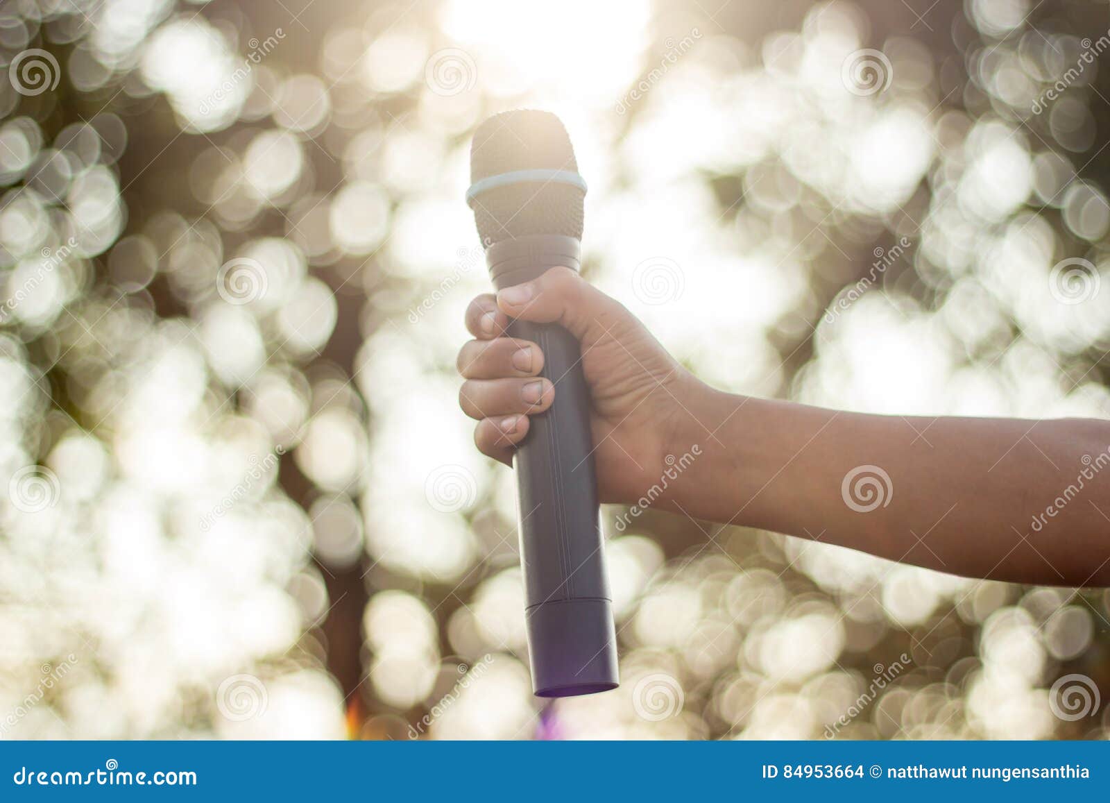 Hand Holding a Single Microphone Against Colourful Background,singing ...