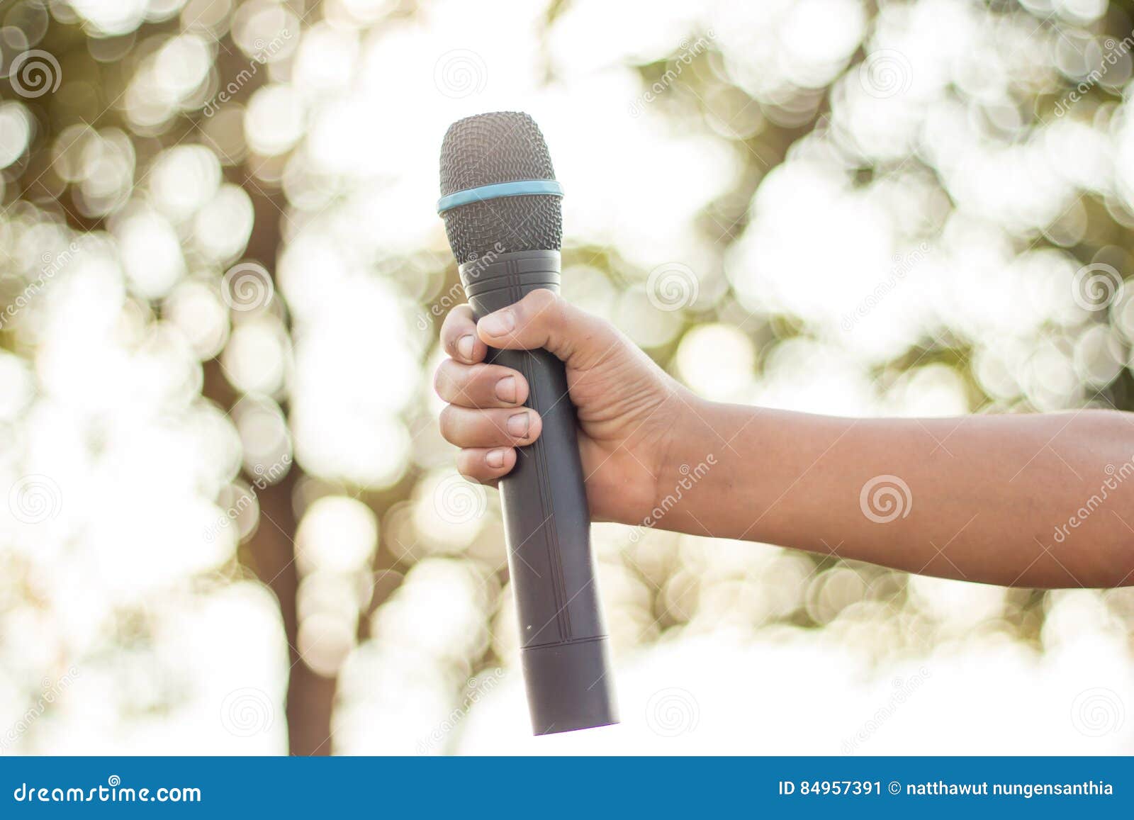 Hand Holding a Single Microphone Against Colourful Background,singing ...