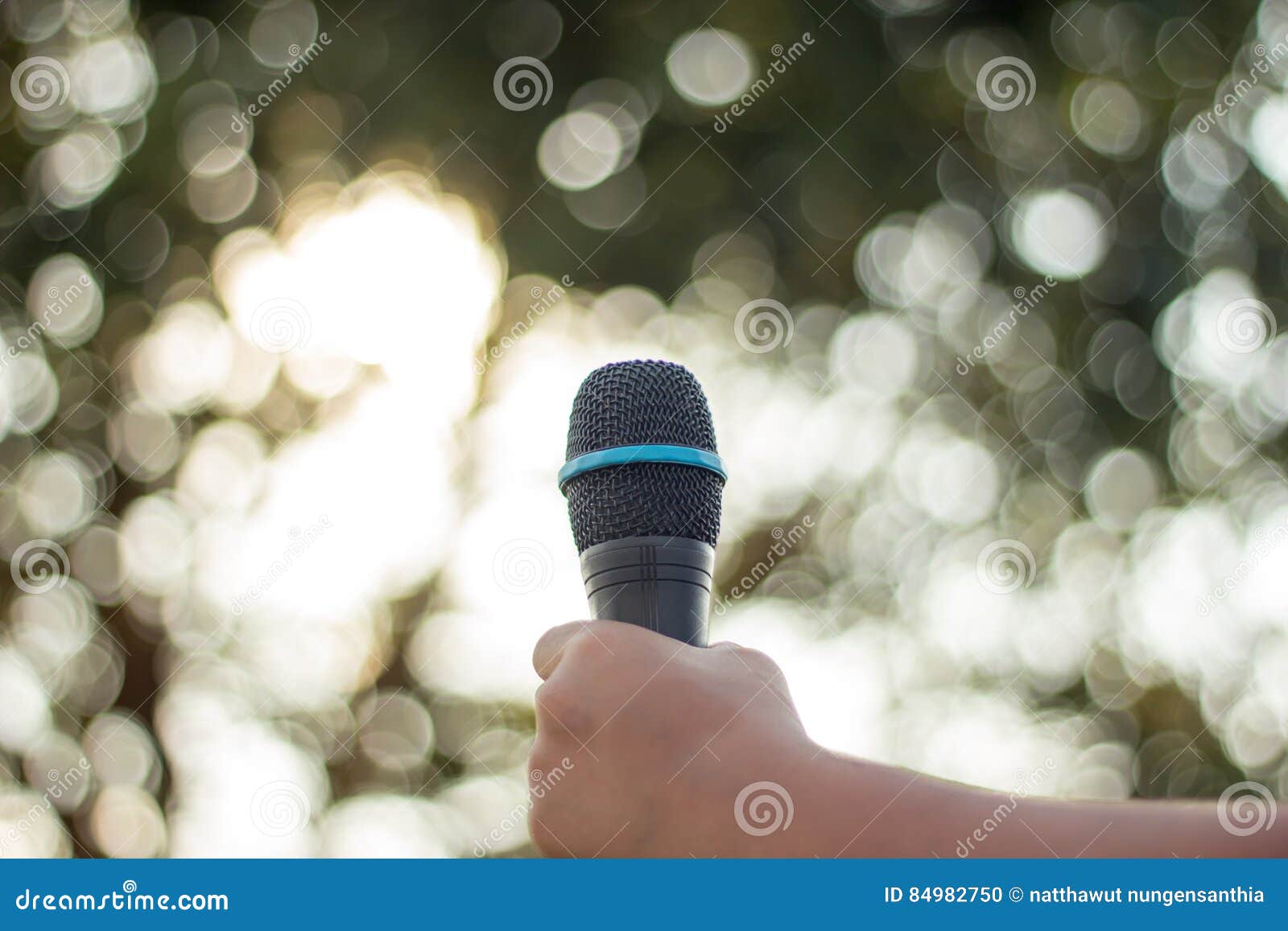 Hand Holding a Single Microphone Against Colourful Background,singing ...