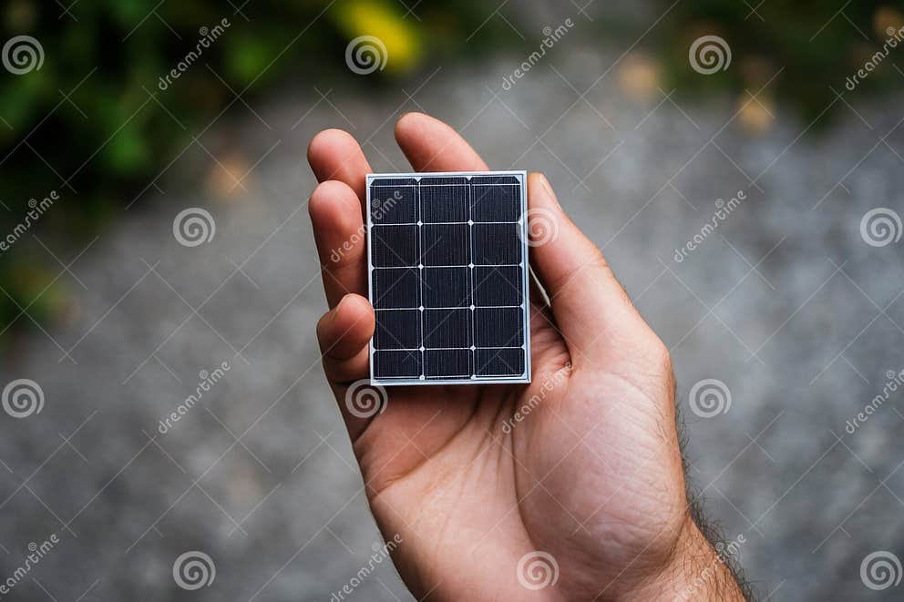 A Hand Holding a Small, Rectangular Solar Panel Stock Illustration ...