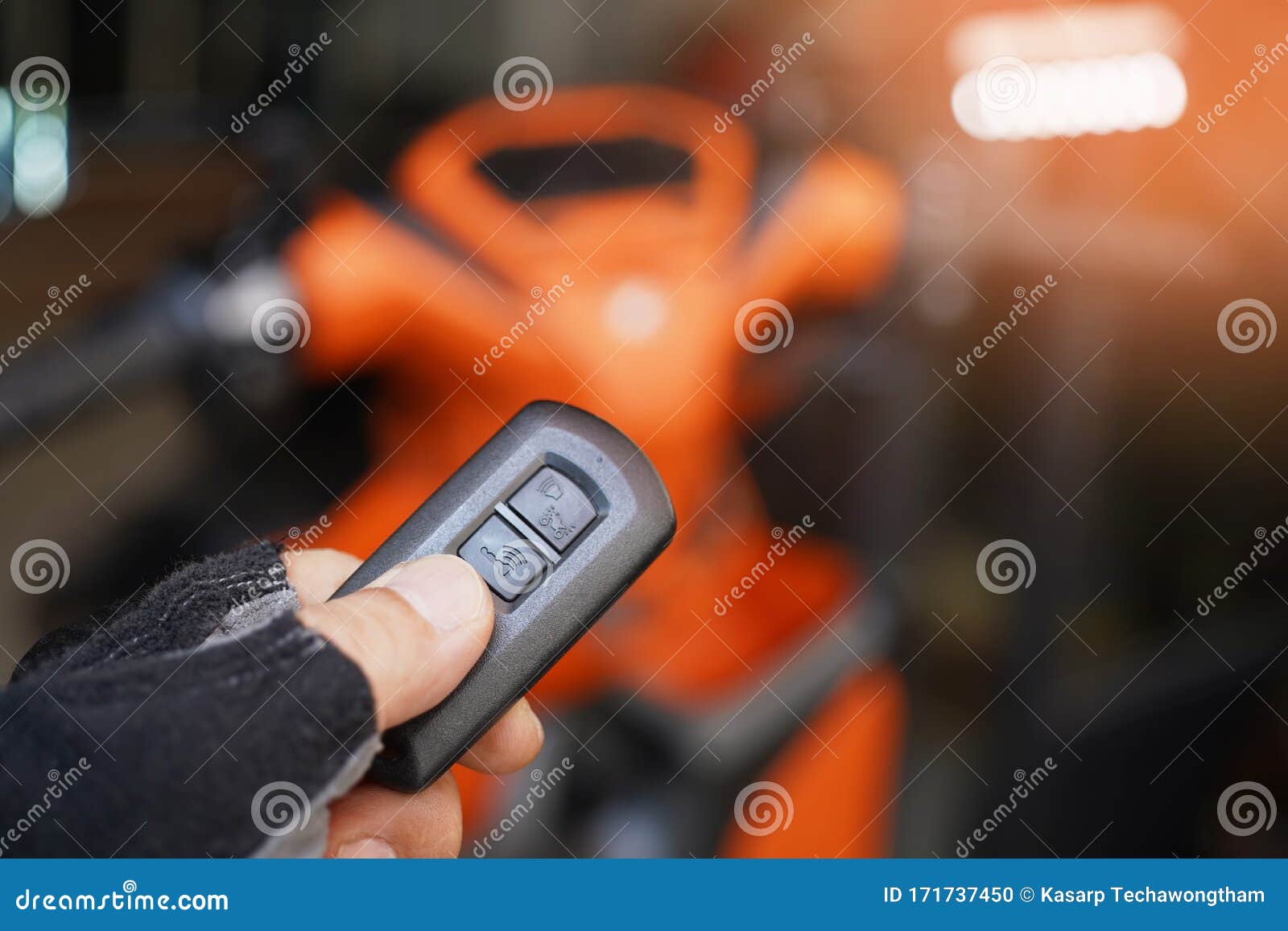Hand Holding Smart Key or Remote Control with Motorcycle Background ...