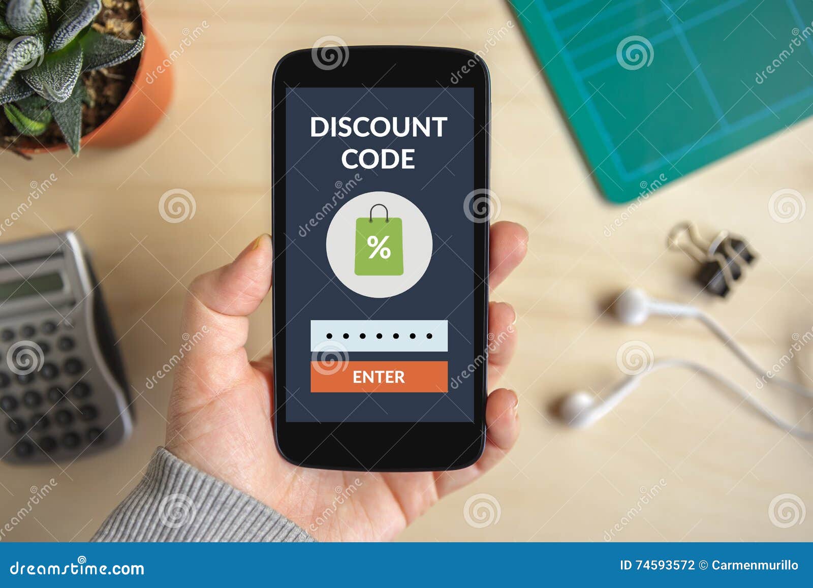 Hand Holding Smart Phone with Discount Code Concept on Screen Stock ...