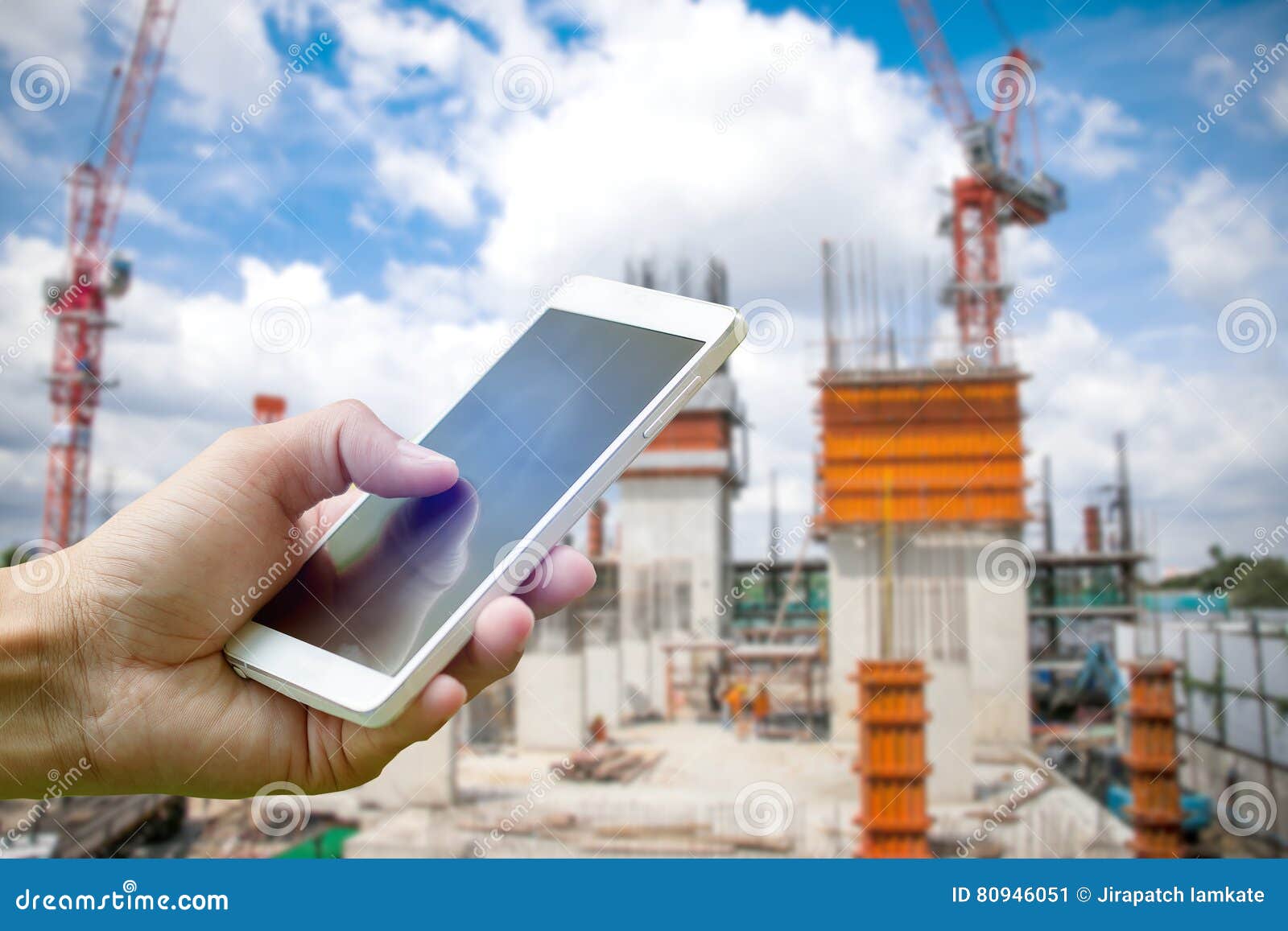 Hand Holding Smartphone on Blurred Construction Site Workers Wit Stock ...