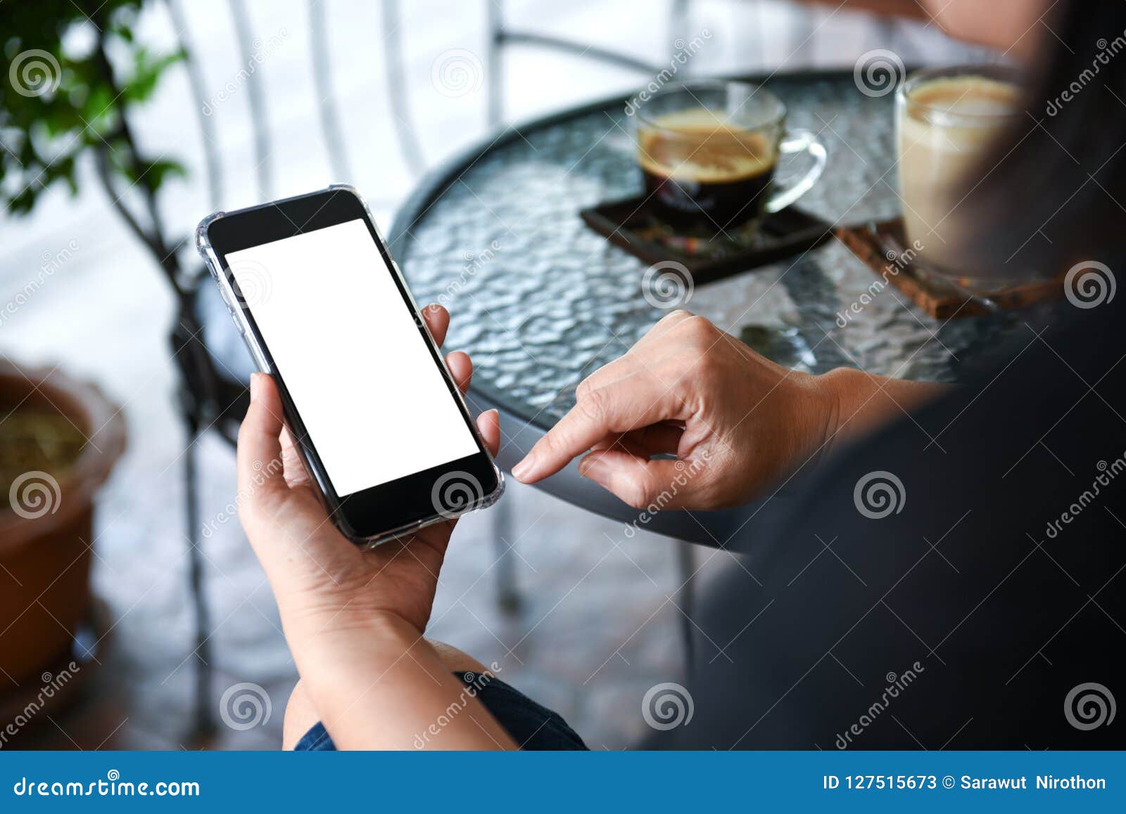Hand Holding Smartphone with Coffee on the Table. Stock Image - Image ...