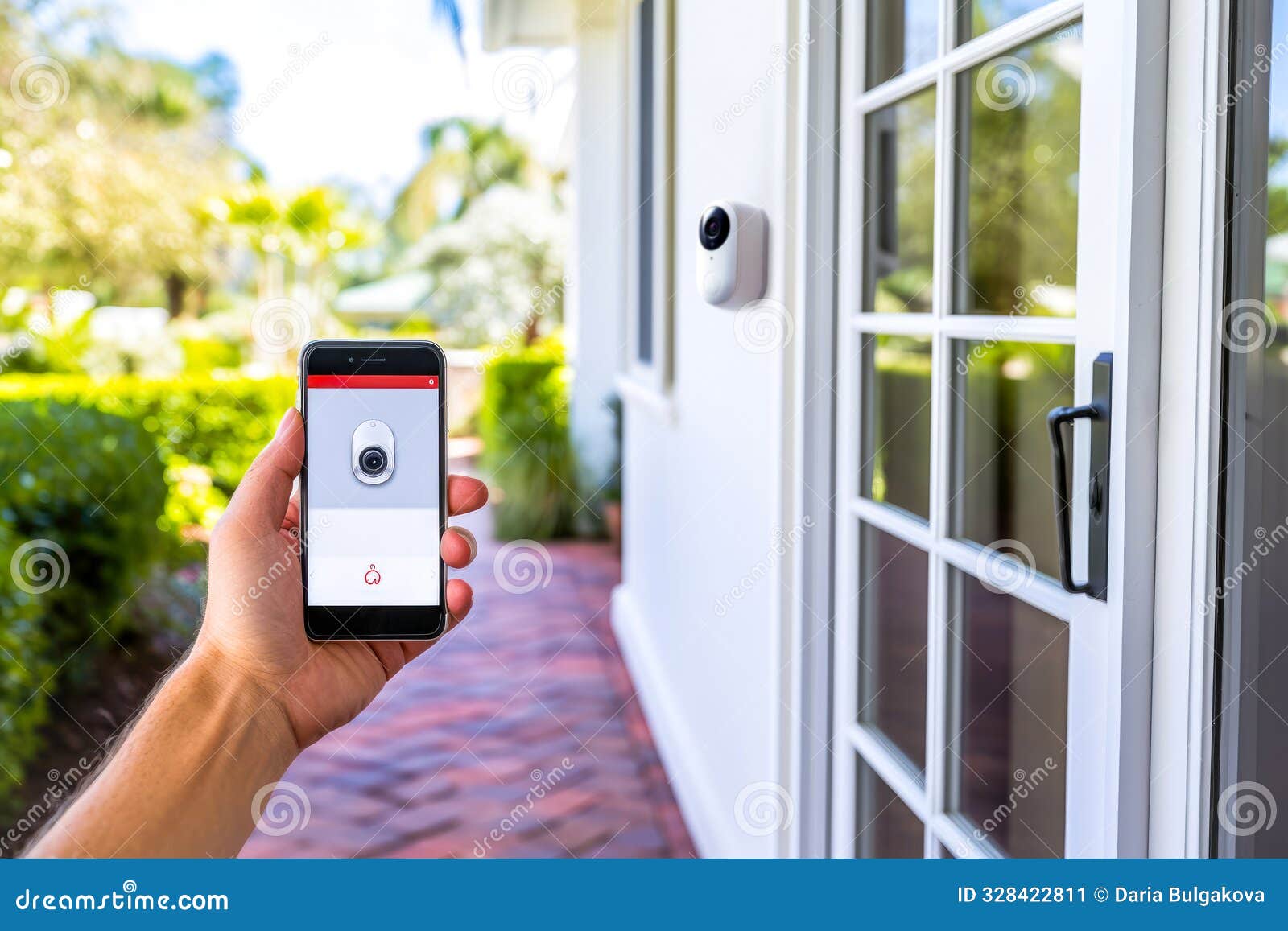 Hand Holding Smartphone Displaying Security Camera Feed with Camera ...