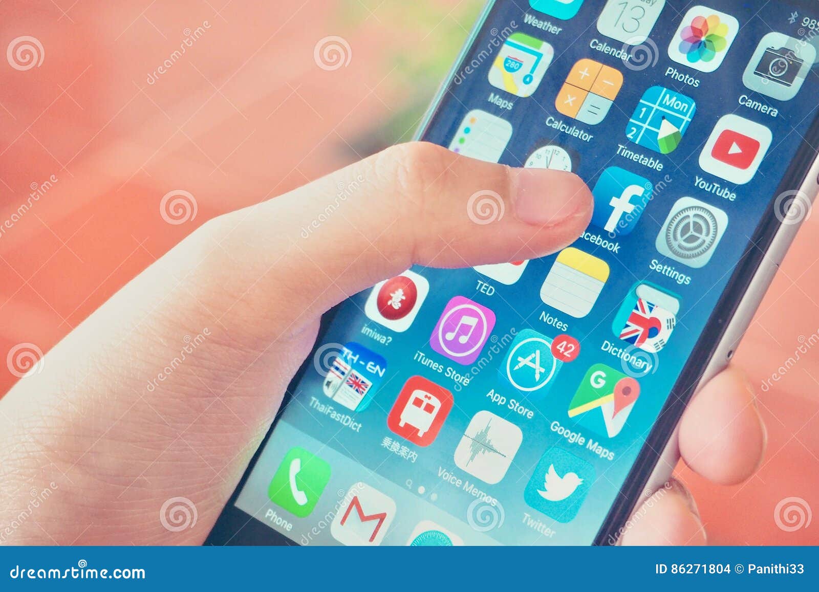 Hand Holding a Smartphone while Touching Facebook App Icon Editorial ...