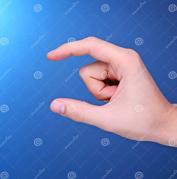 Hand Holding Something Small in Its Fingers Stock Photo - Image of ...