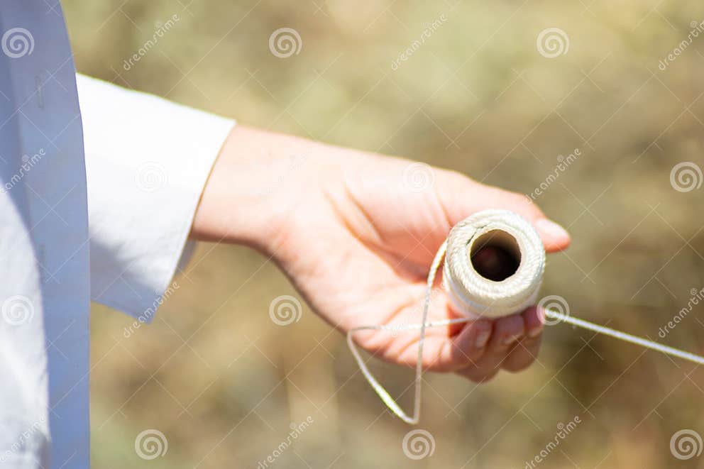 Hand Holding a Spool of Thread Stretching it Stock Illustration ...