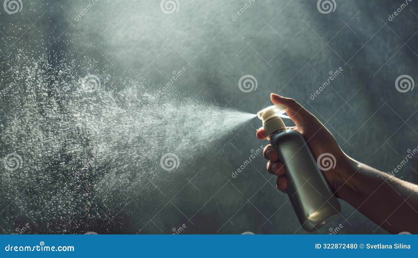 Hand Holding a Spray Bottle, Misting a Shiny Surface for a Thorough and ...