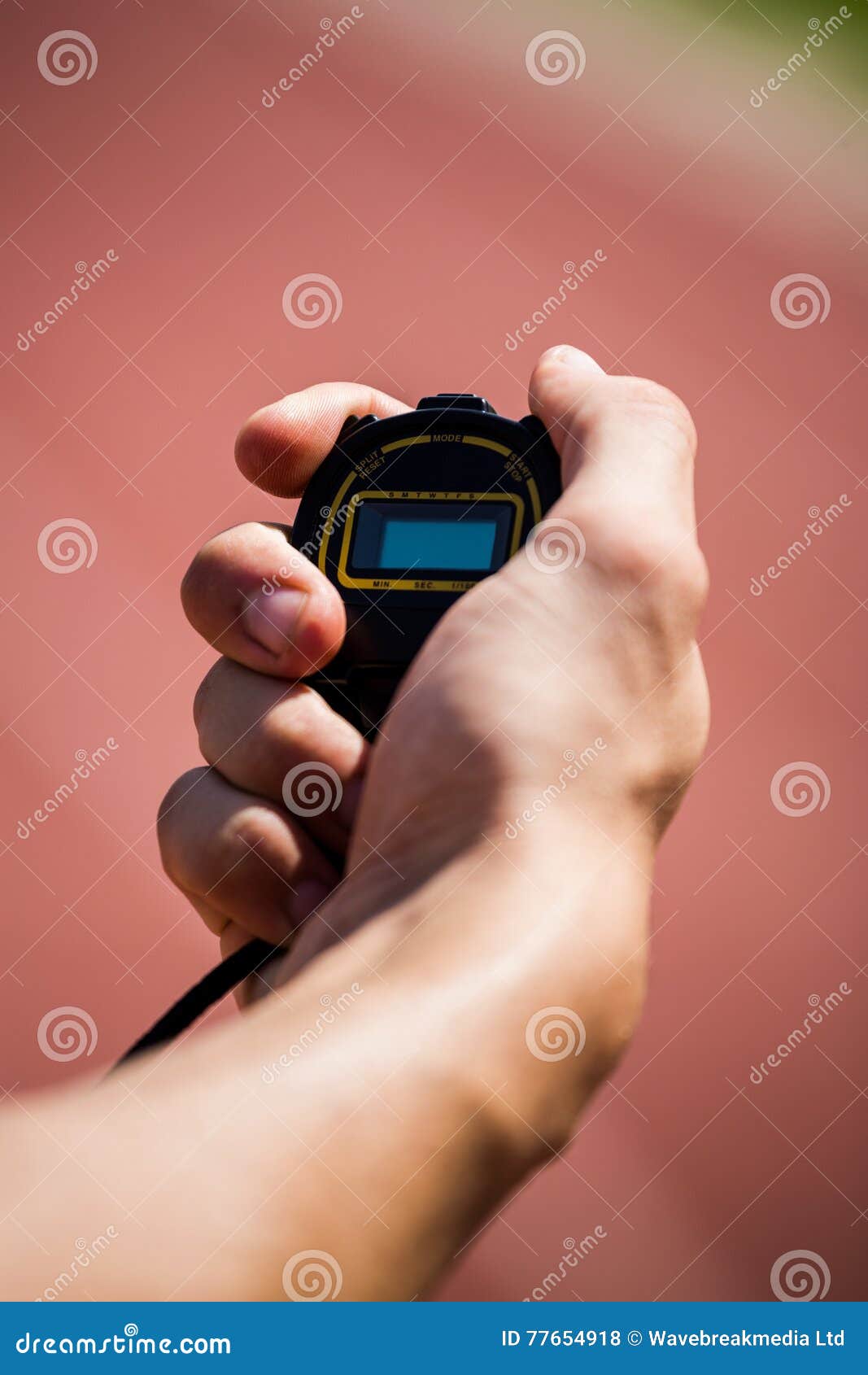 Hand holding a stopwatch stock photo. Image of stadium - 77654918