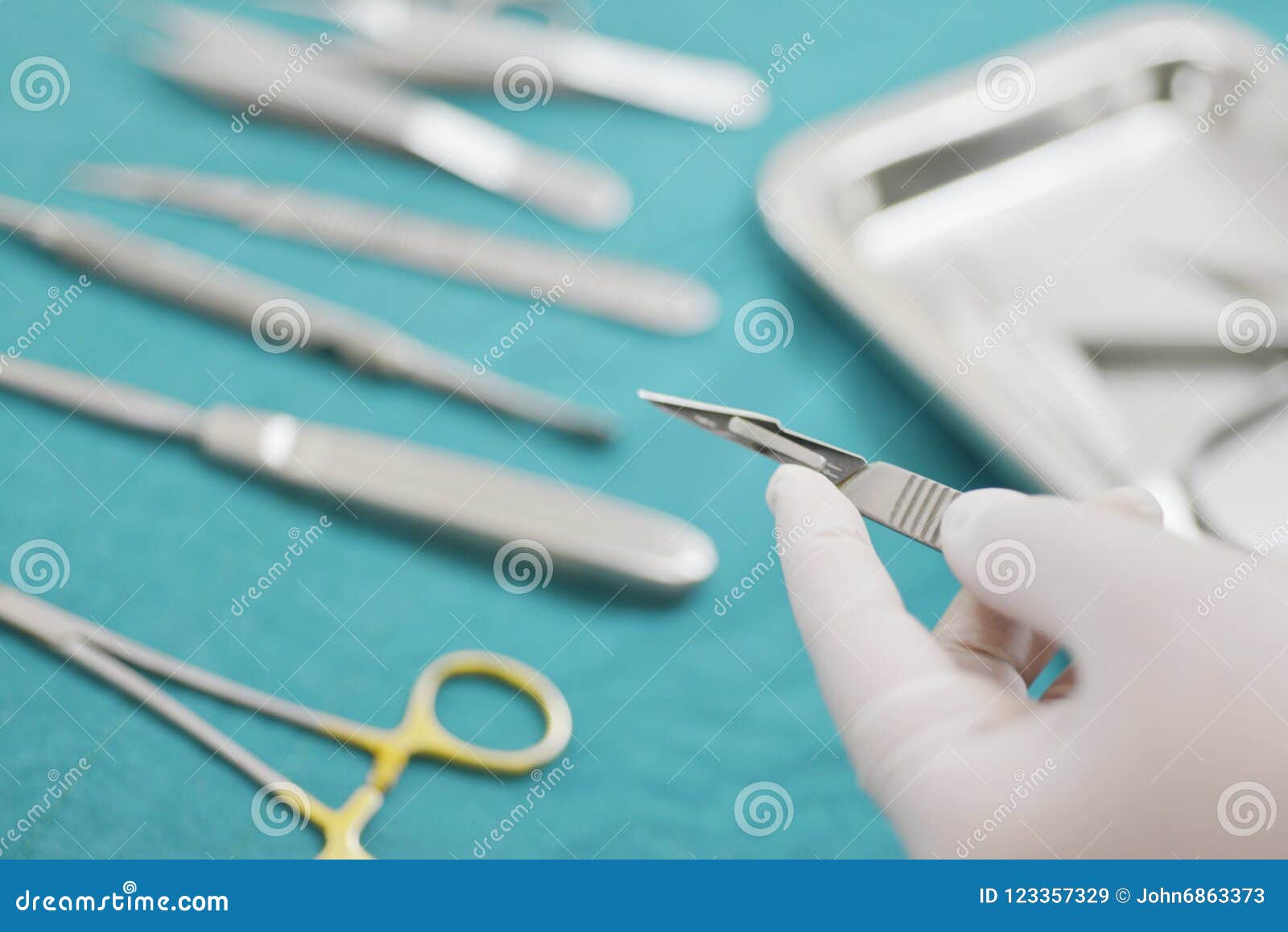 Hand Holding Surgical Instruments Stock Image - Image of clinic, green ...