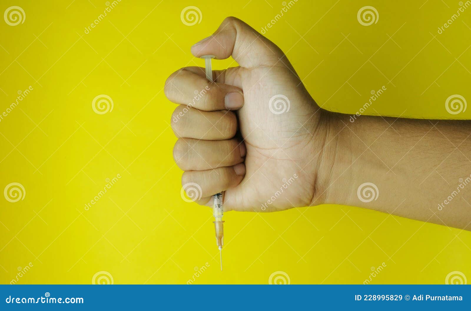 Hand holding syringe stock image. Image of injection - 228995829