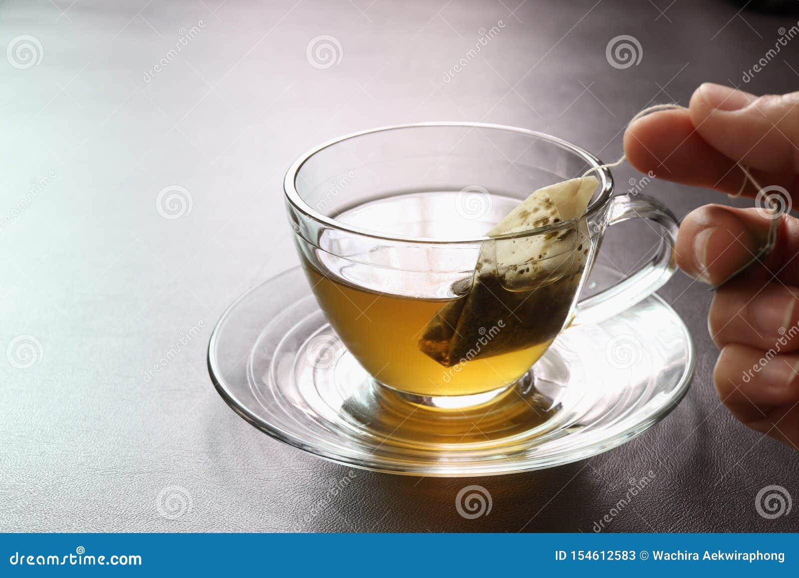 Hand Holding a Tea Bag Out of a Glass of Tea Stock Image - Image of ...