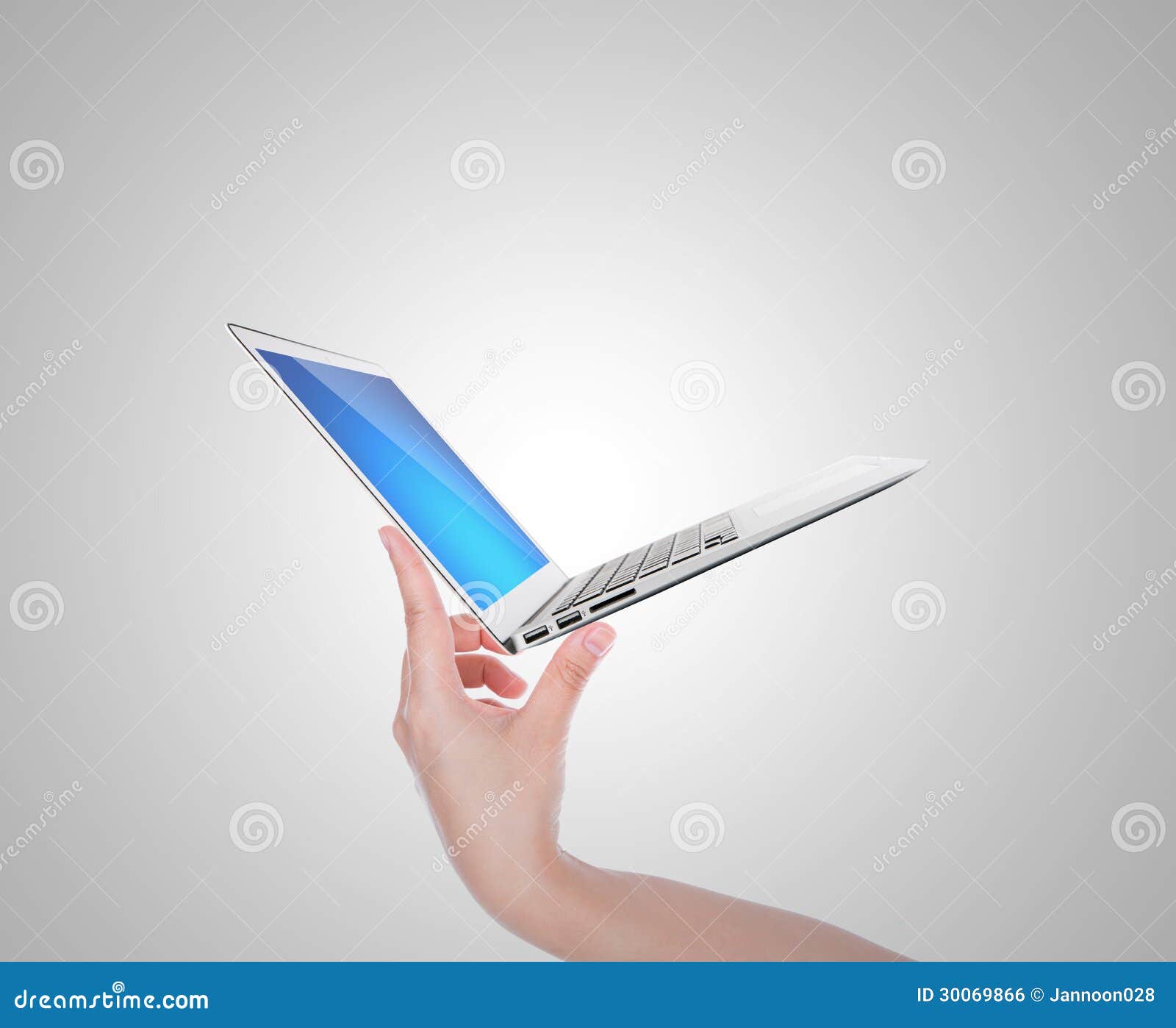 Hand holding thin laptop stock photo. Image of human - 30069866