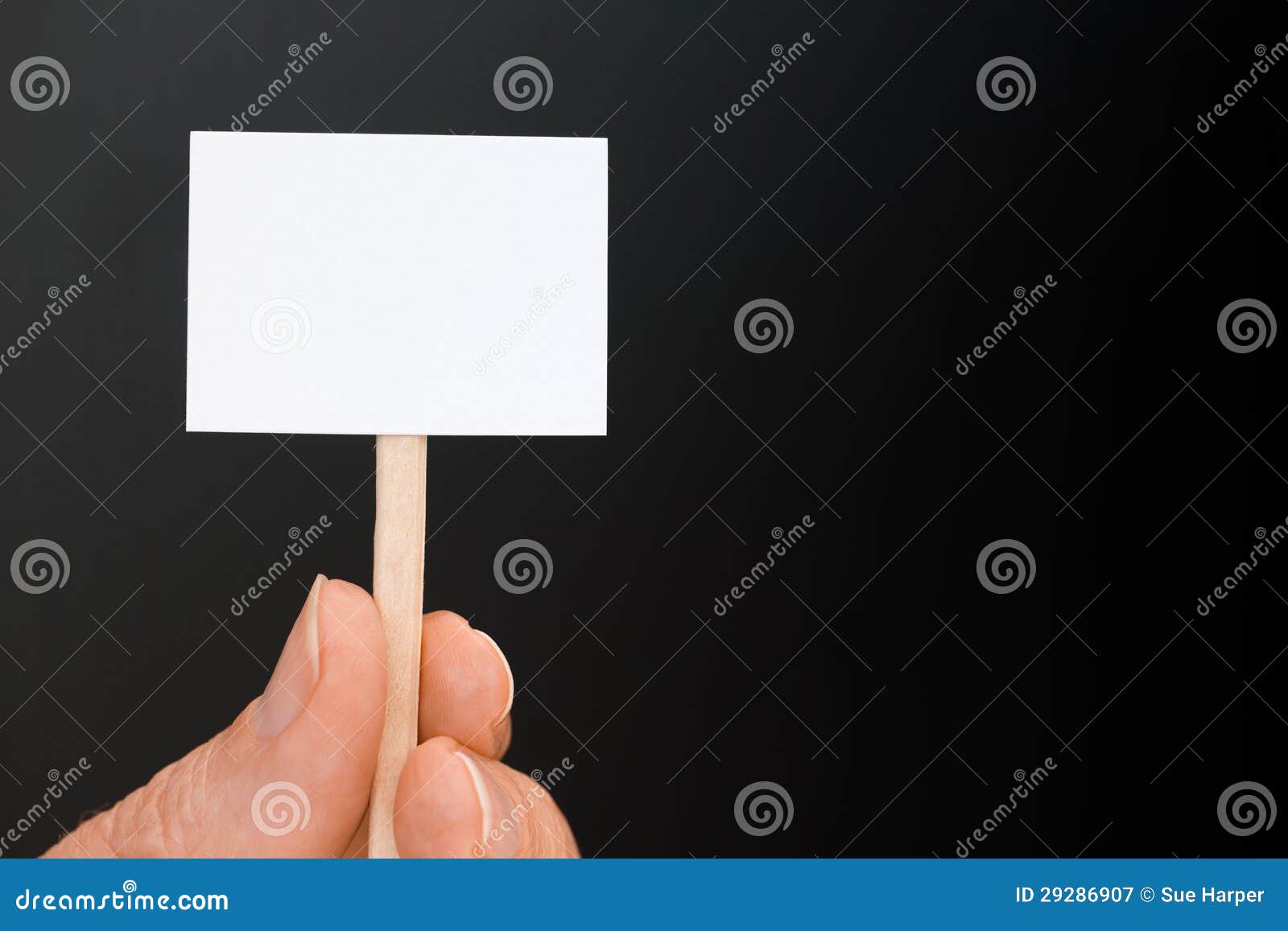 Hand Holding Tiny Sign on Black with Copy Space Stock Image - Image of ...