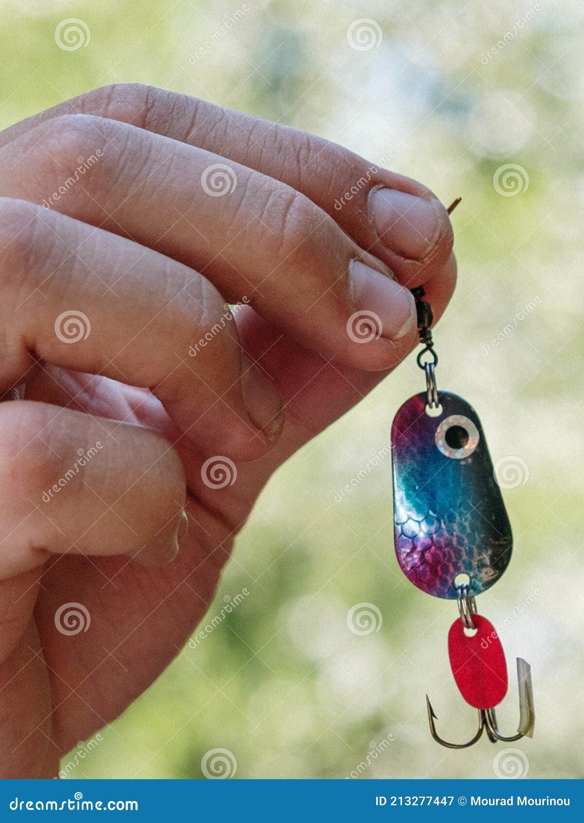 A Hand Holding a Triple Hook in the Form of a Fish Stock Image - Image ...
