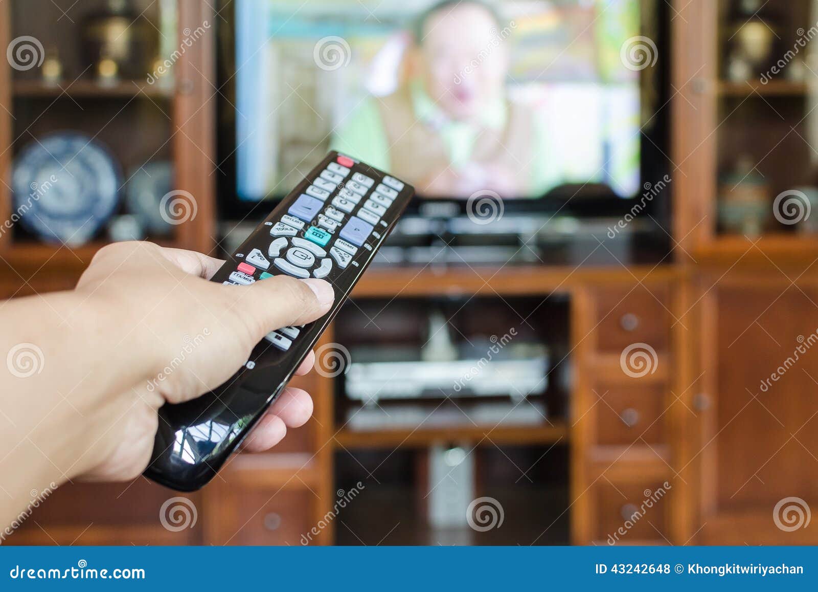 Hand Holding TV Remote Control with Television Stock Photo - Image of ...