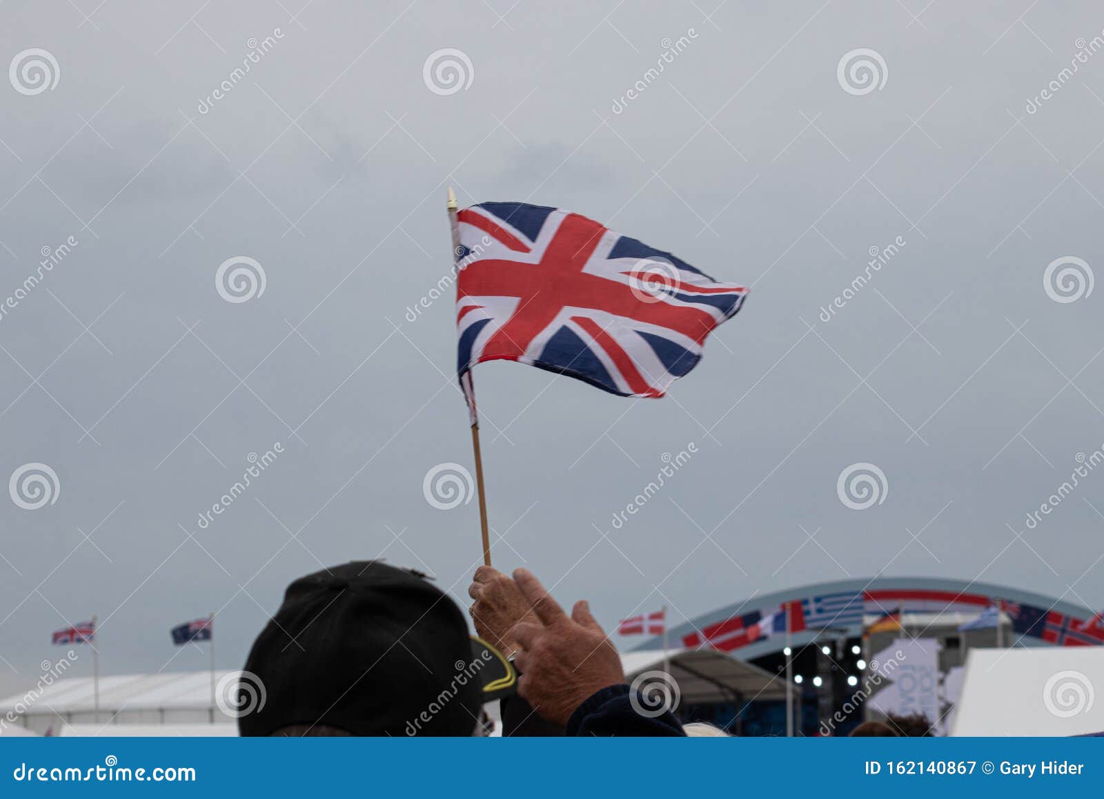 A Hand Holding Up a Union Jack or British Flag Stock Image - Image of ...