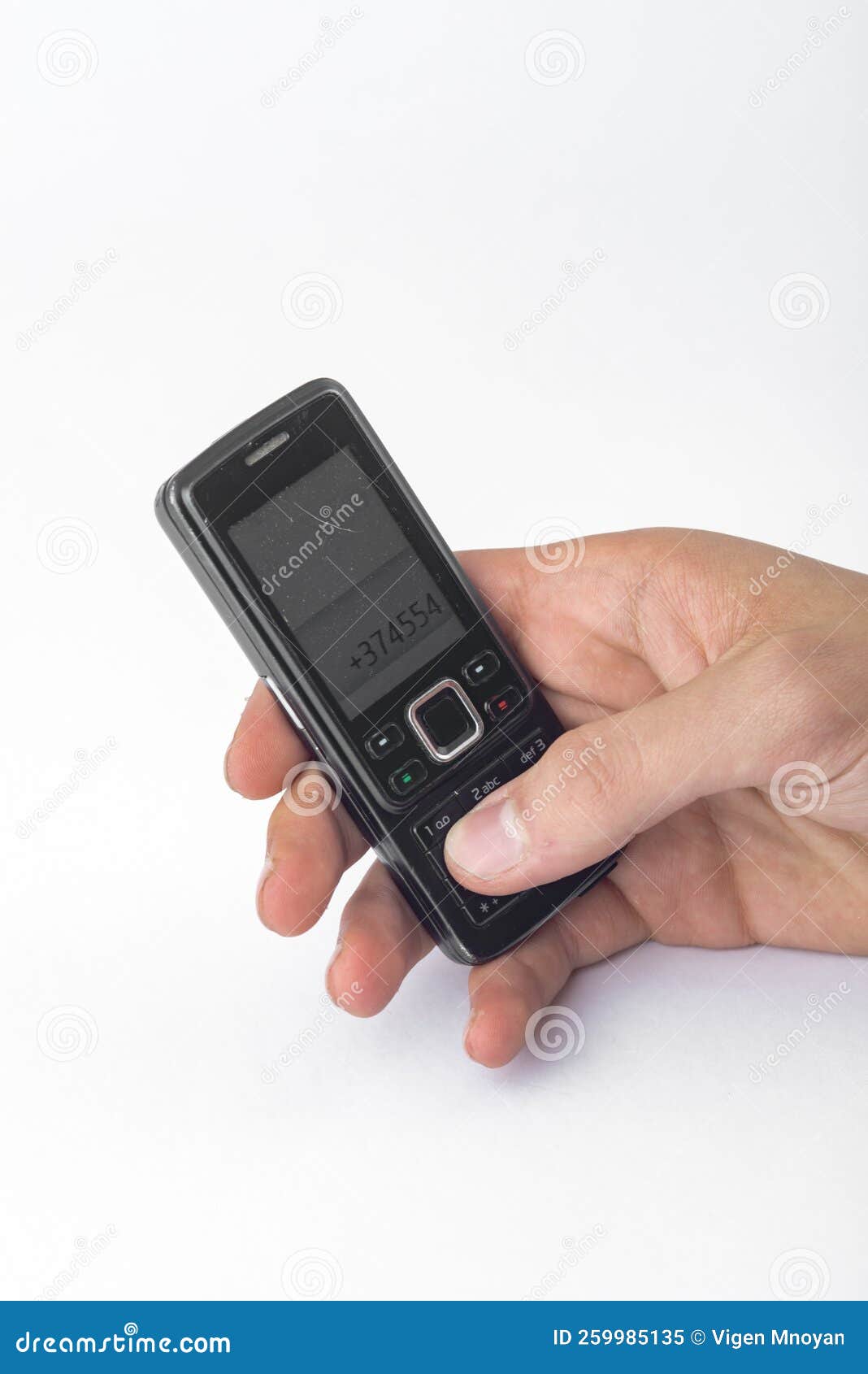Hand Holding a Vintage Mobile Phone Isolated on White Background ... Hand Holding a Vintage Mobile Phone Isolated on White Background ...