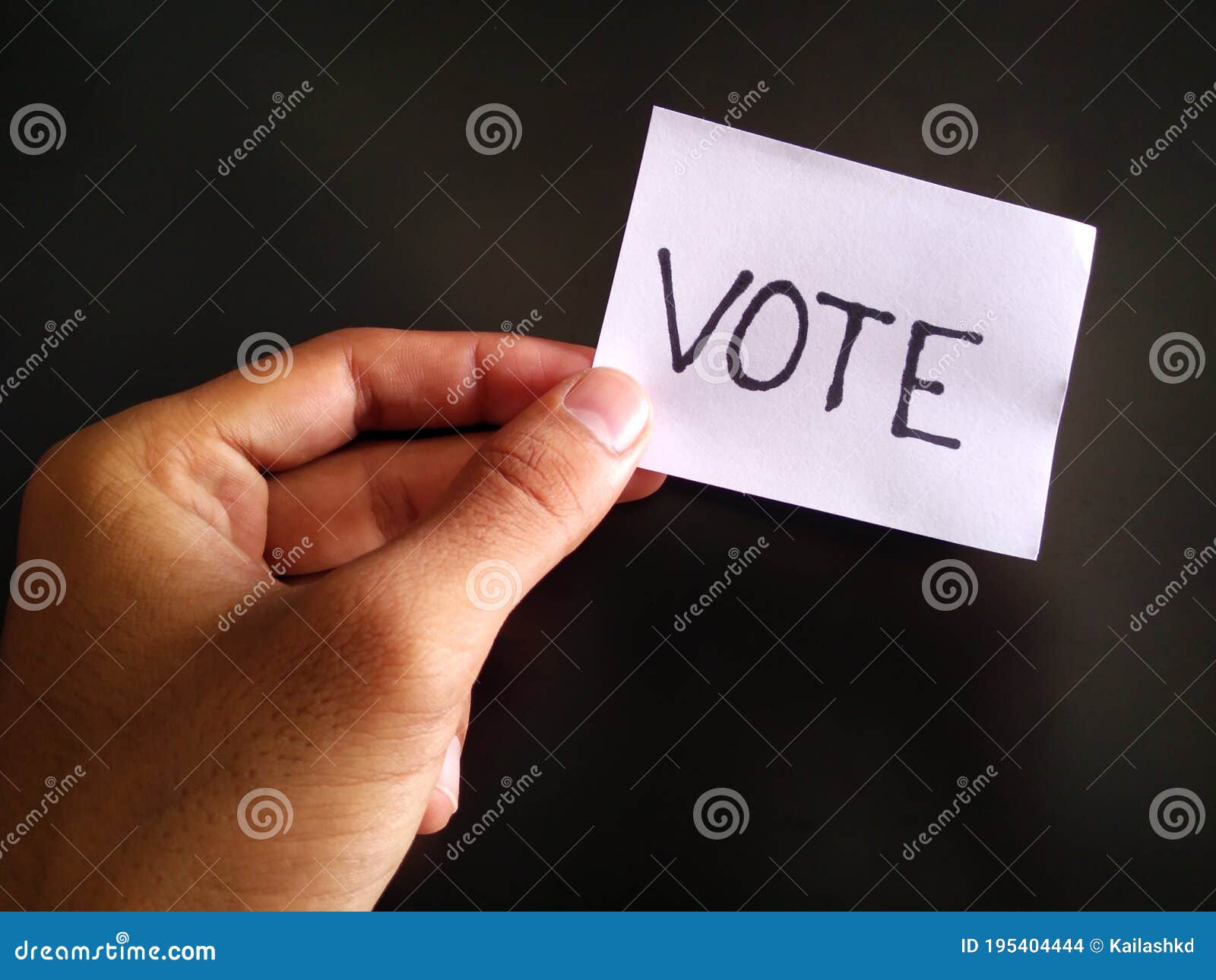 Hand Holding a Vote Written Paper Note in Election Stock Photo - Image ...