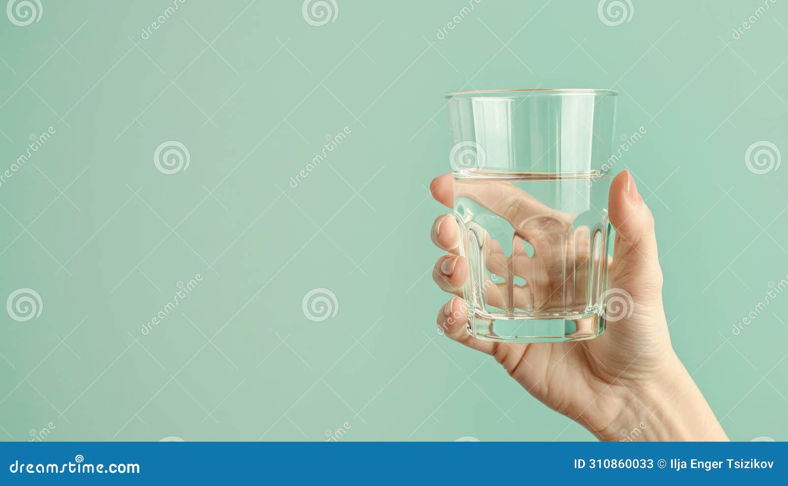 Hand Holding Water Glass on Pastel Background with Ample Copy Space for ...