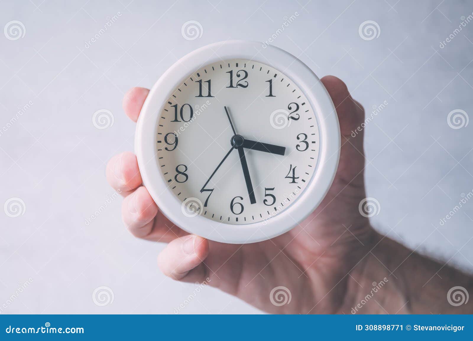 Hand Holding White Analog Clock, Time is Half Past Three Stock Image ...