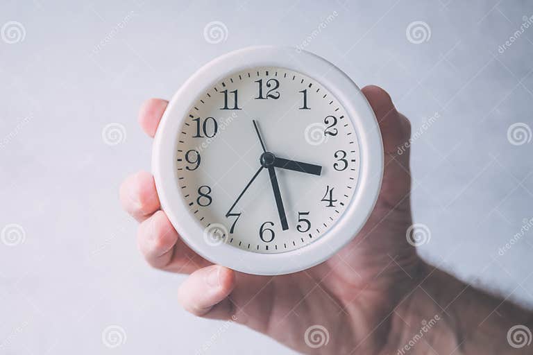 Hand Holding White Analog Clock, Time is Half Past Three Stock Image ...