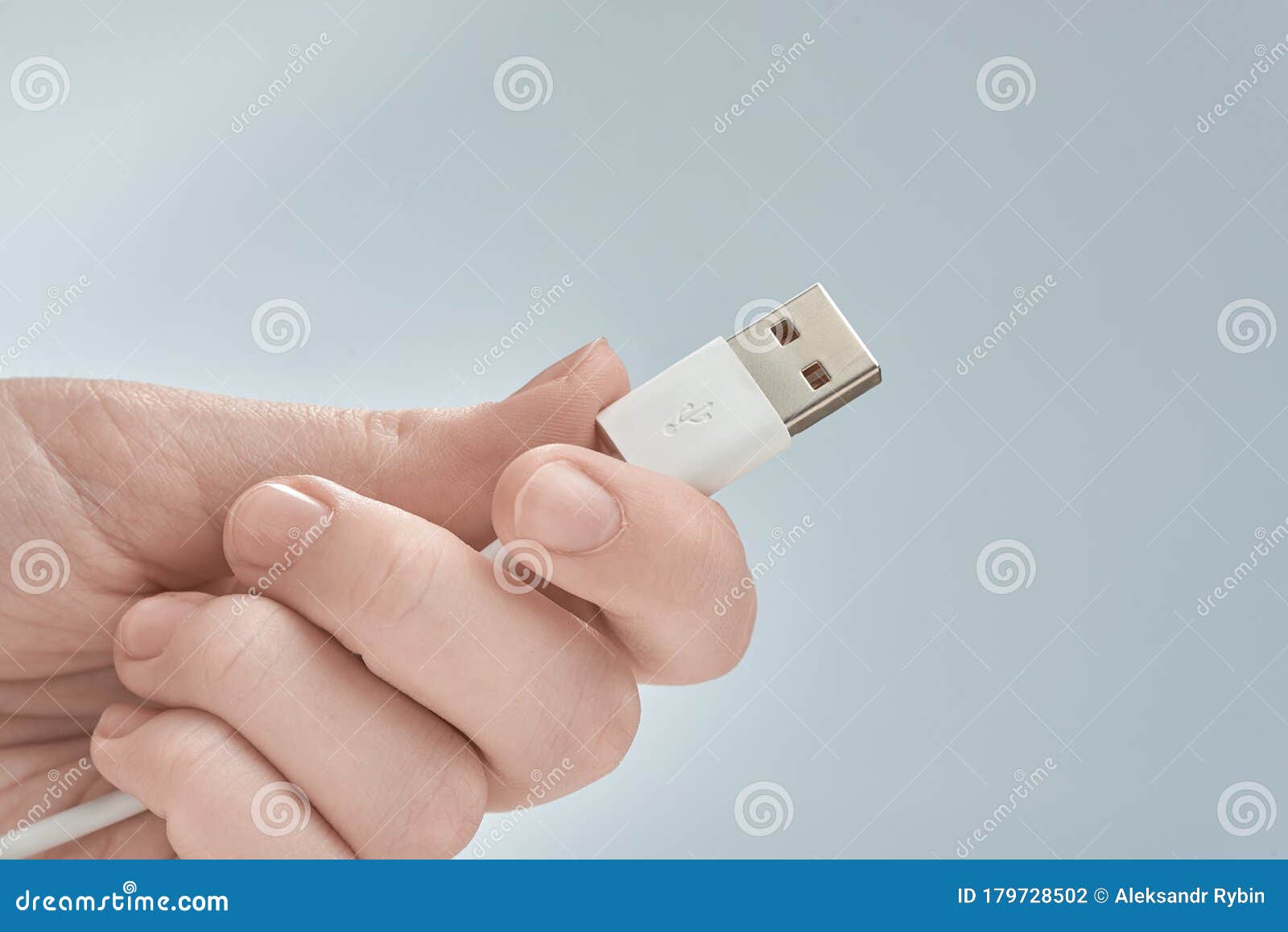 Hand Holding White USB Cable on Gray Background Stock Photo - Image of ...