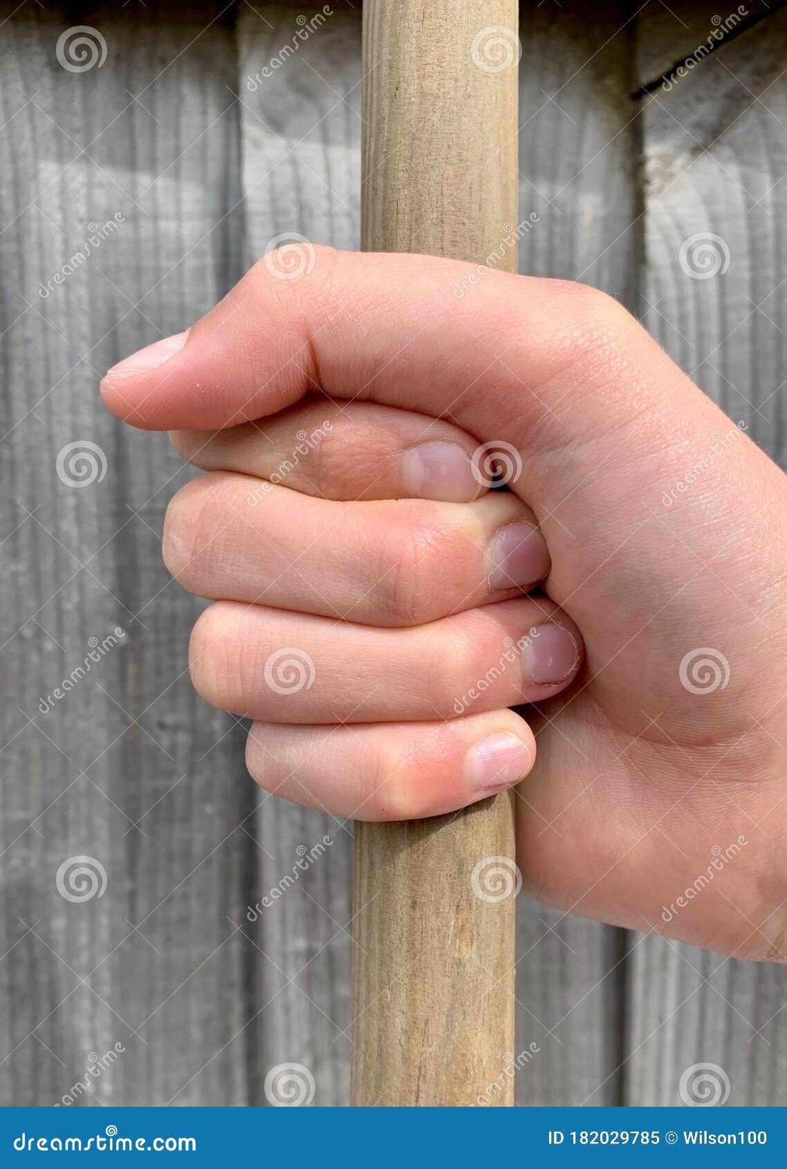 Hand holding a wooden pole stock image. Image of tight - 182029785