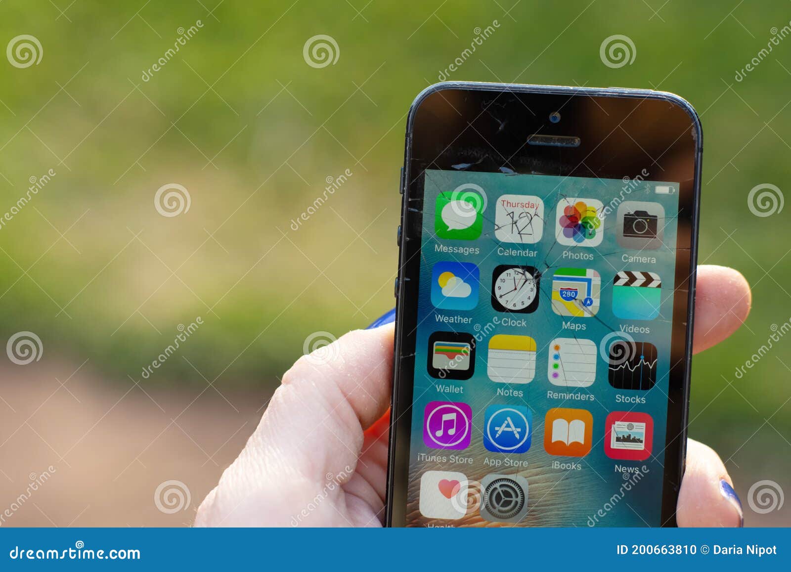 Hand Holding Working Smartphone with Badly Smashed Screen. Cracked ...