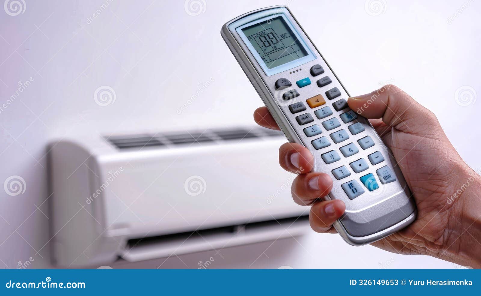 A Hand Holds an Air Conditioner Remote Control with a Digital Display ...