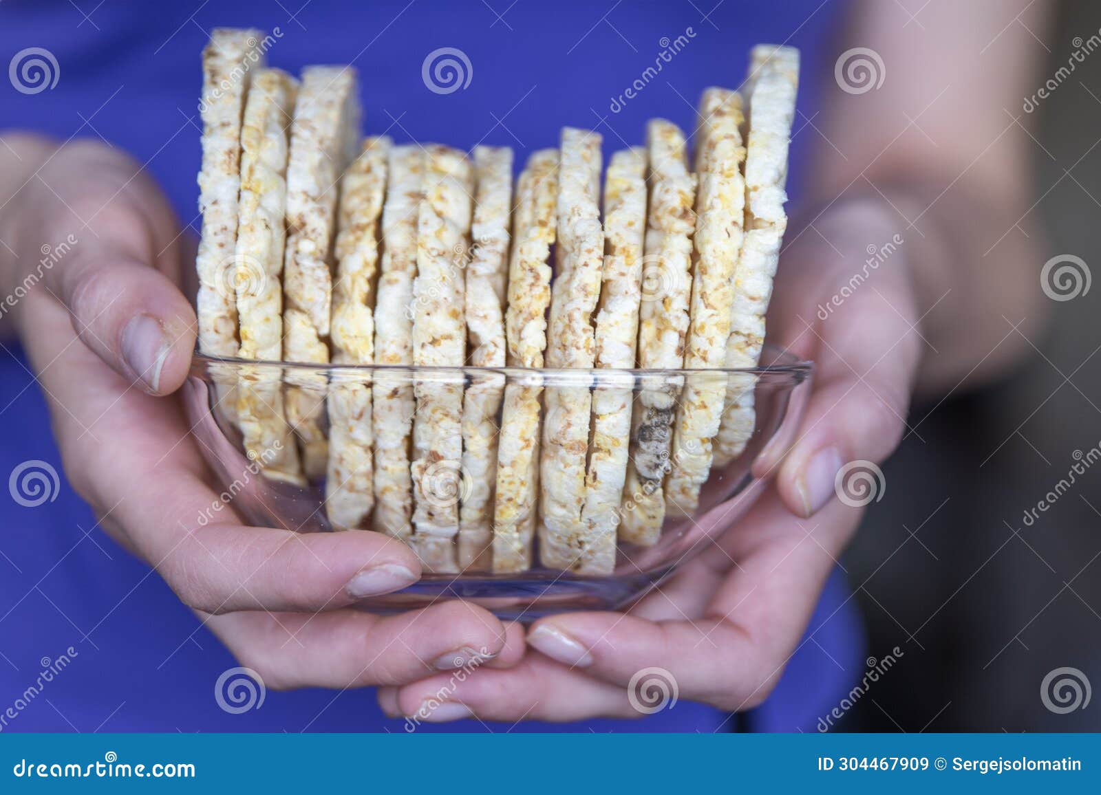 A Hand Holds a Bowl of Corn Chips Close-up. the Process of Eating a ...