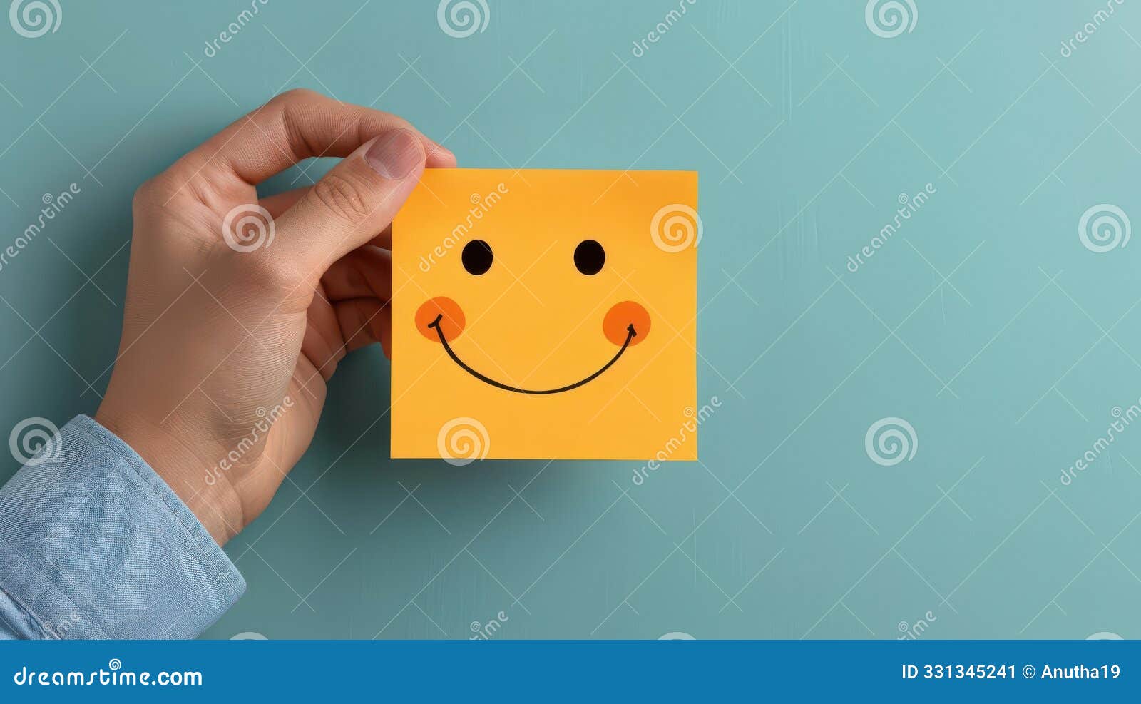 A Hand Holds a Bright Yellow Sticky Note with a Smiling Face Against a ...