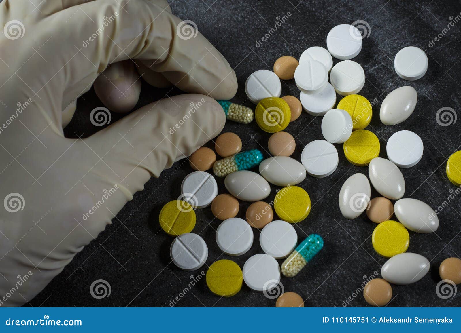 A Hand Holds a Capsule Over a Pile of Tablets Stock Image - Image of ...