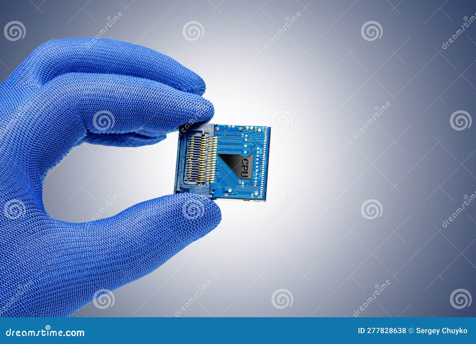 Hand Holds a Cpu Against the Grey Blue Background. Concept of ...