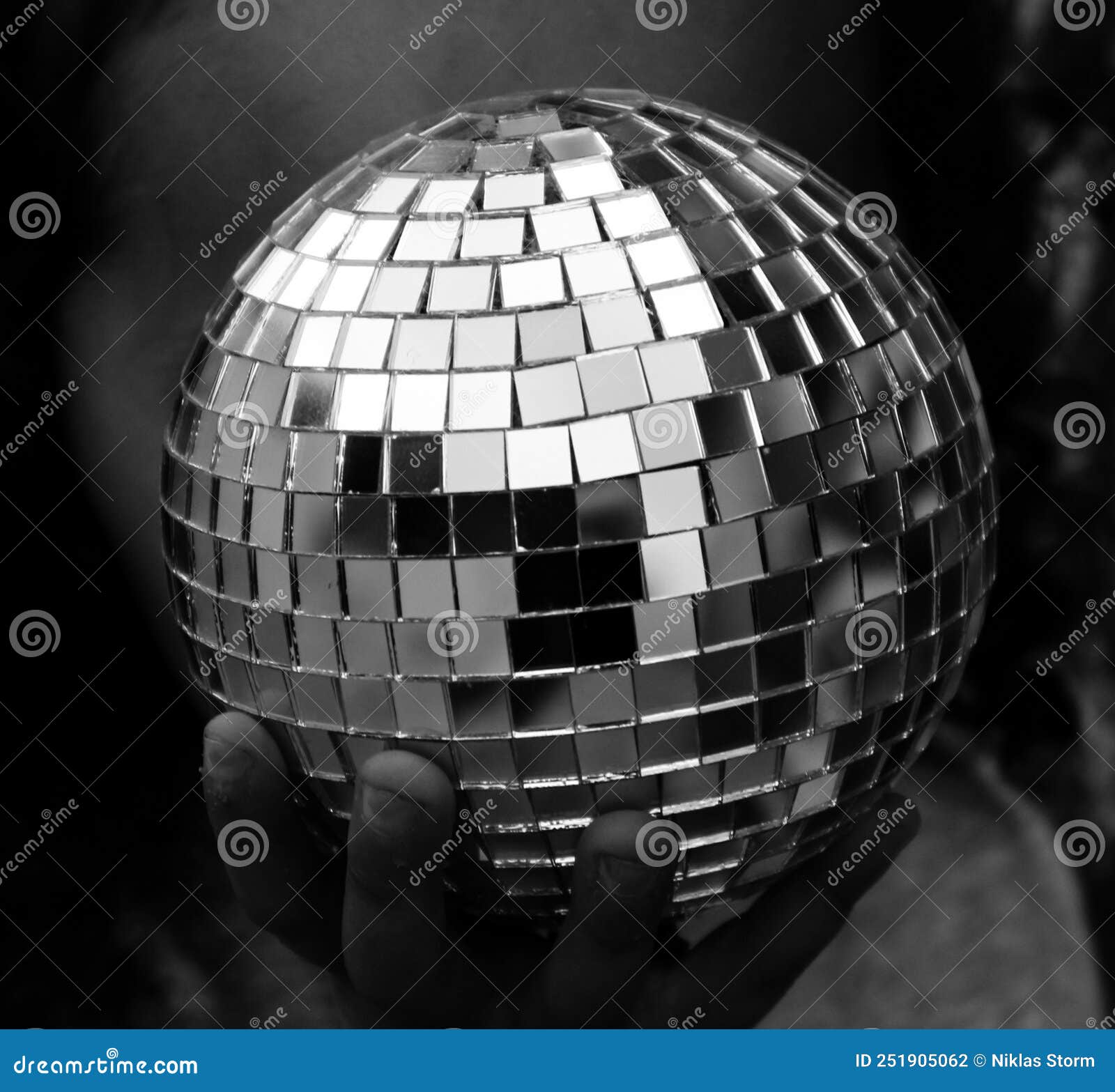 A hand holds a disco ball stock photo. Image of hand - 251905062