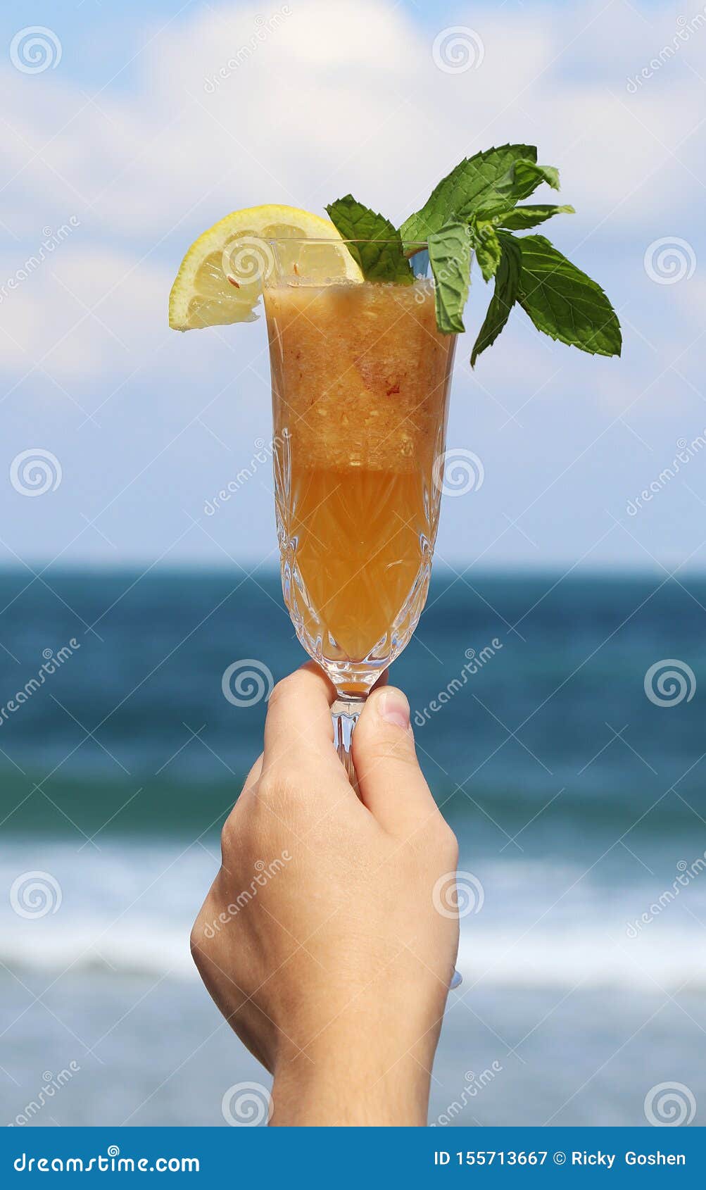 A Hand Holds A Glass With Fruit Cocktail Stock Image Image Of Clouds
