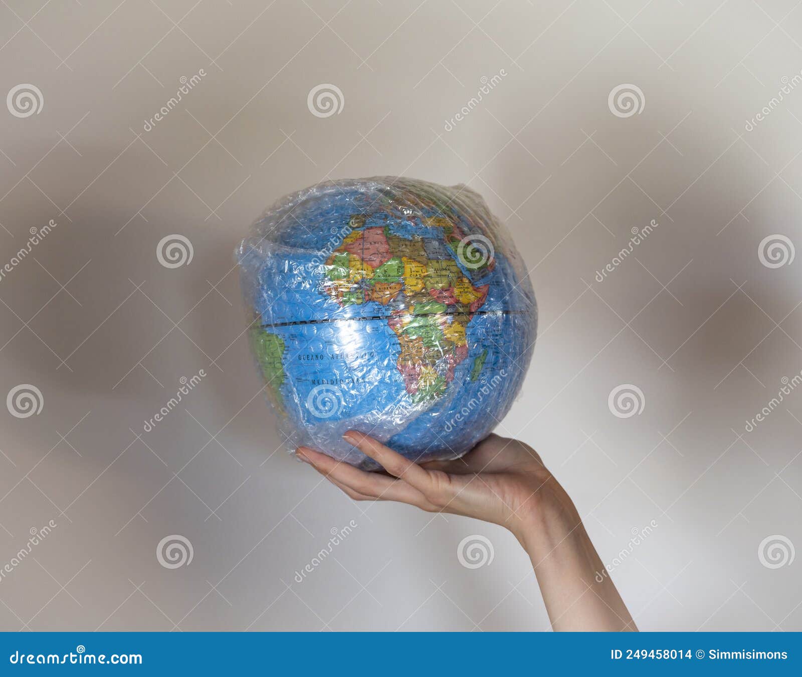 Hand Holds a Globe Wrapped in Plastic Stock Photo - Image of globe ...