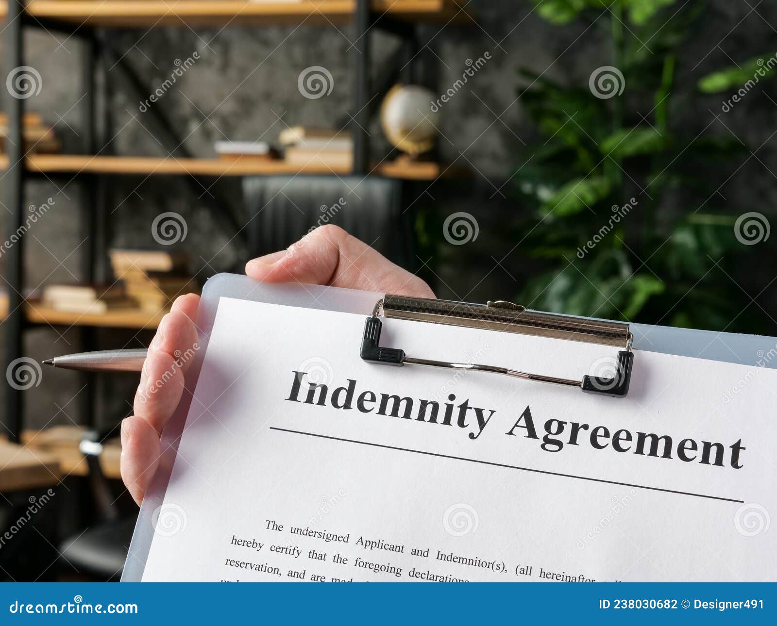 Hand Holds Indemnity Agreement for Signing in the Office. Stock Photo ...